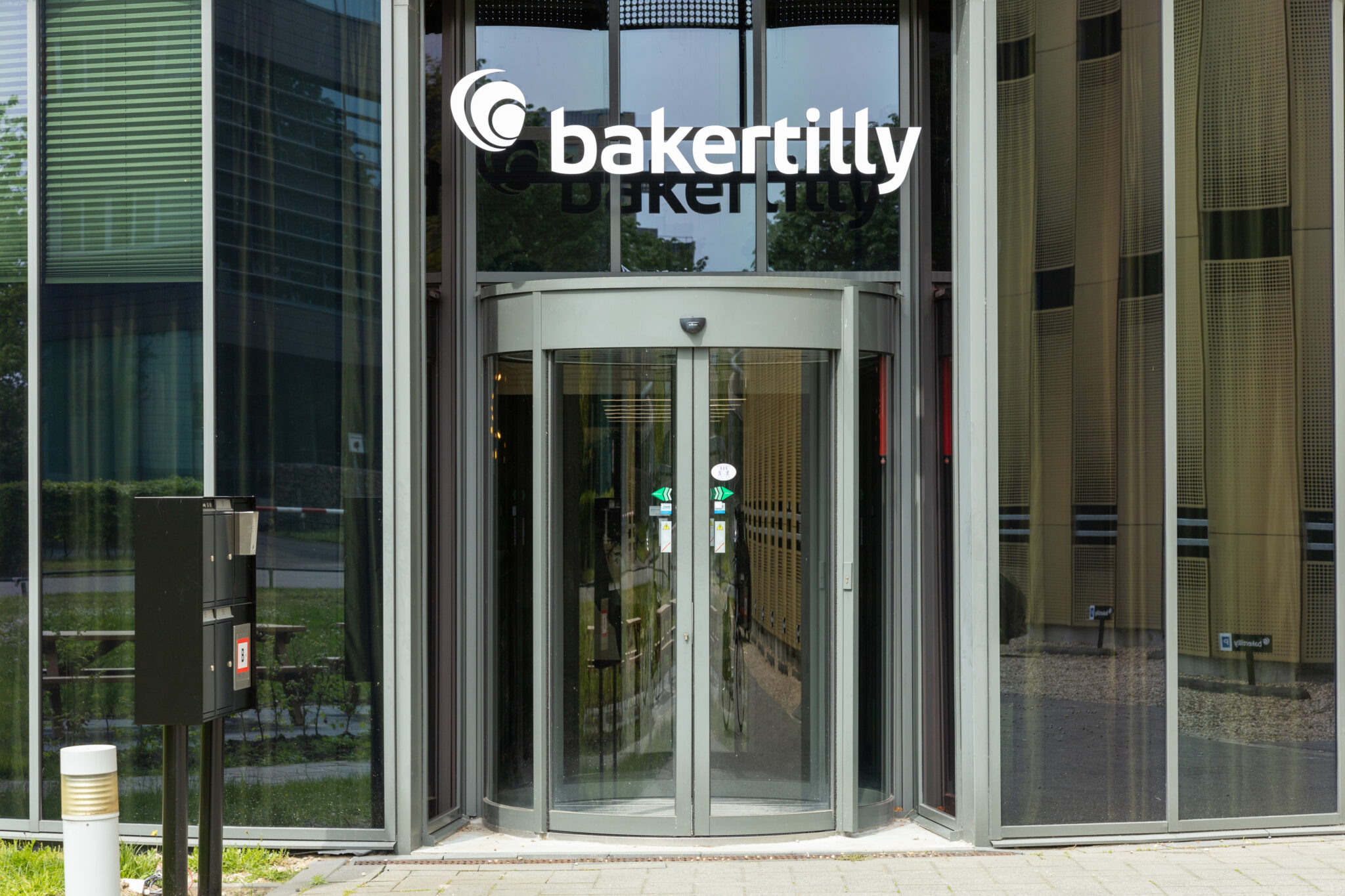 Baker Tilly logo sign above the entrance of the Bakertilly office ...